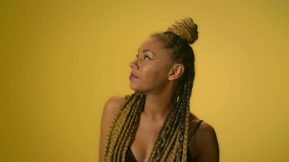 African American Woman with Dreadlocks Dancing in Slow Motion on Yellow ...