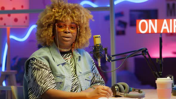 Female Podcast Host Speaking on Camera in Recording Studio, Stock Footage