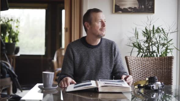 Man Reminiscing From Photo Album, Stock Footage | VideoHive