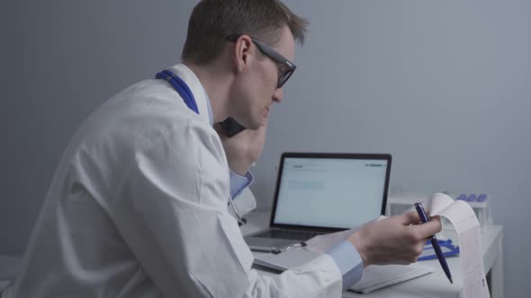 Electrocardiogram ECG in Hand Doctor Cardiologist, Stock Footage ...