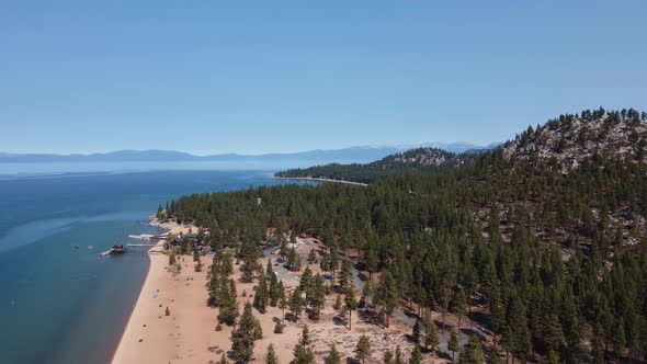 Counterclockwise drone shot of Nevada Beach, the surrounding forest ...