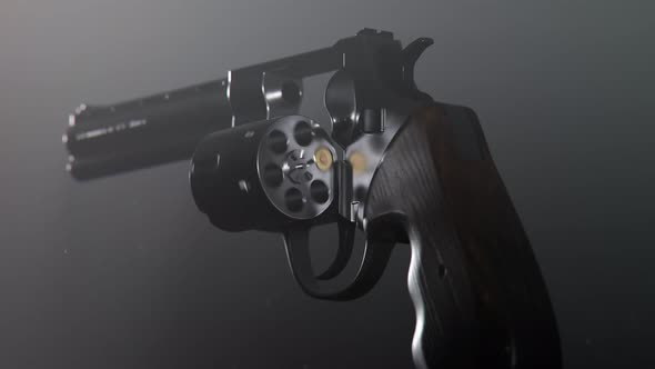 Revolver with spinning cylinder holding one bullet. Playing russian ...