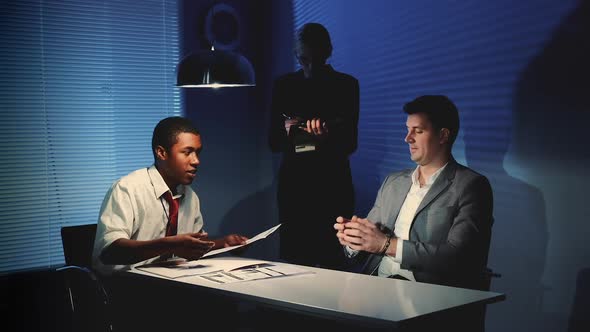 African Detective Questioning Suspect Caucasian Man in Interrogation ...