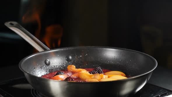 Chef Prepares Flambe Dish with Fruits on Fire in Restaurant Kitchen ...