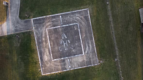 Aerial top down shot of empty heliport or helipad on field during ...
