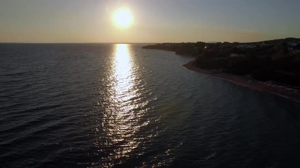 Aerial View of Shoreline and Sea with Boats at Sunset, Stock Footage