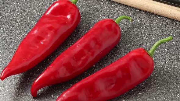 Three whole fresh red pointed bell peppers close up , Stock Footage