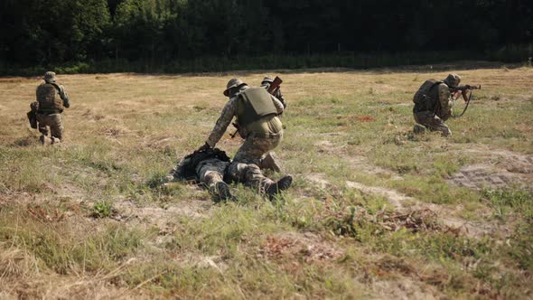 Rescue Soldier Approaches a Wounded Warrior Checks for Signs of Life ...