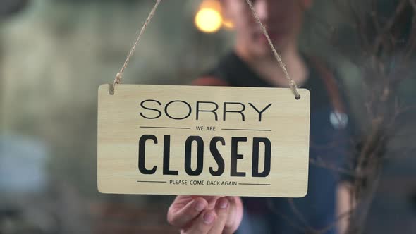 4K Asian man coffee shop owner turning hanging closed sign to open on ...