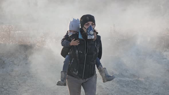 The surviving mother carries her son in a gas mask through clouds of ...