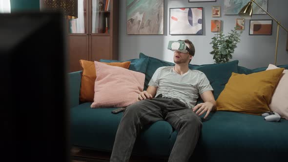 Tired Man Playing Video Games on Modern Next Gen Console with Gamepad ...