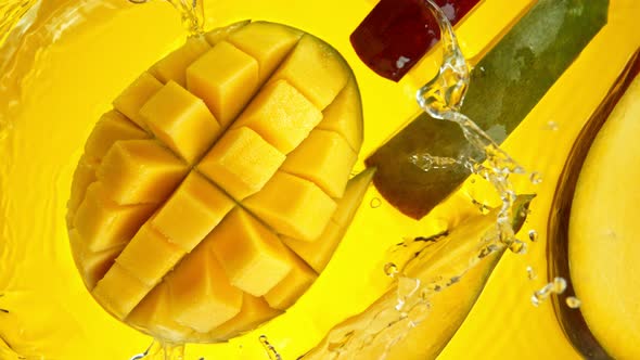 Super Slow Motion Shot of Mango Falling and Splashing Into Water on ...