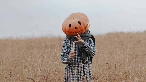 Funny Little Teen Girl in a Giant Gourd Head Performing a Ritual Over ...