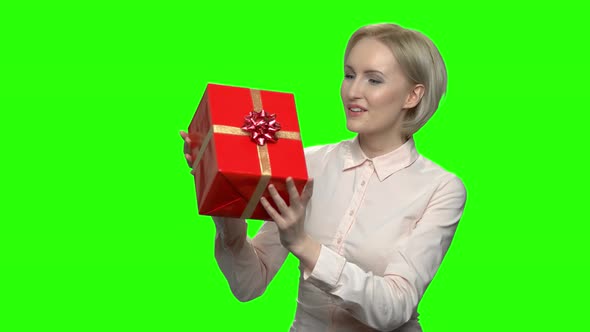 Woman Shaking Gift Box with Excitement, Stock Footage | VideoHive