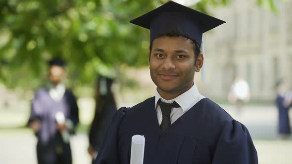Charming Hispanic Graduate Smiling and Showing Diploma for Camera ...