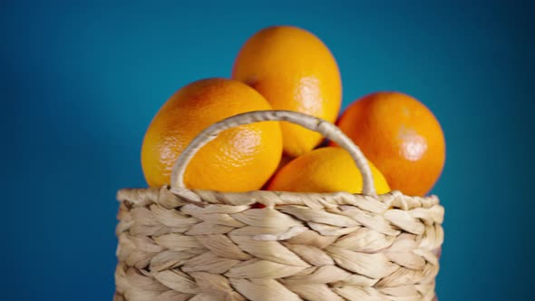 Bright Orange Oranges are Spinning in a Basket on a Blue Background ...