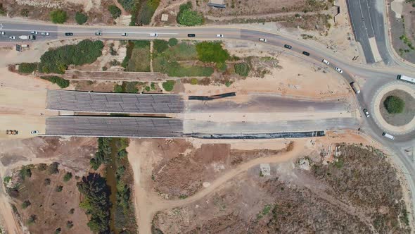 Aerial footage of large highway construction project with tunnels and ...