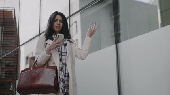 Frustrated Businesswoman Using Cellphone Outdoors. Angry Woman Walking ...