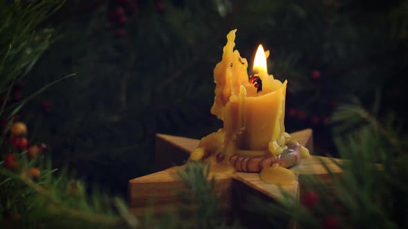 Burning candle in christmas wreath on rustic table, top view, Stock Footage