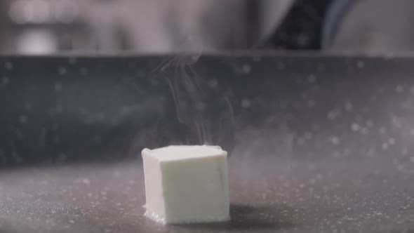 Slow Falling of the Two Pieces of Butter Cube on Frying Pan and Melting ...