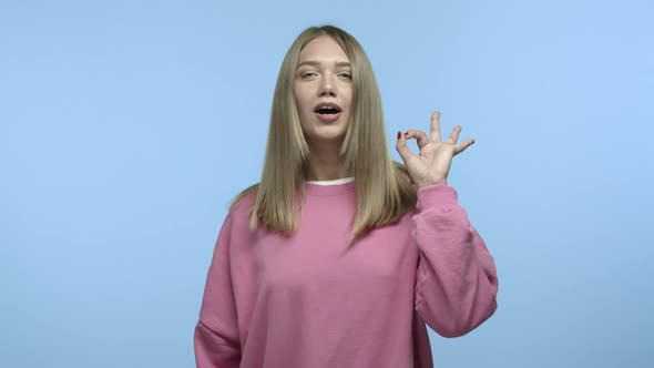 Young Attractive Woman Saying Okay Assuringly Showing OK Sign and Nod ...