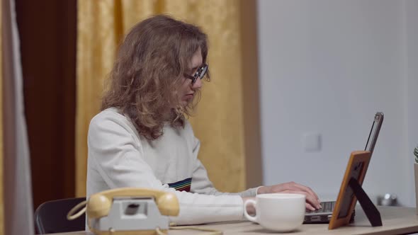 Side View of Exhausted 1980s Geek Typing on Vintage Laptop Keyboard and ...