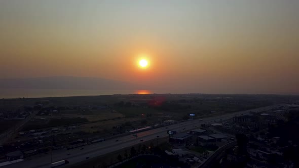 Beautiful aerial red sunset in a smoggy sky from summer wildfires. View ...