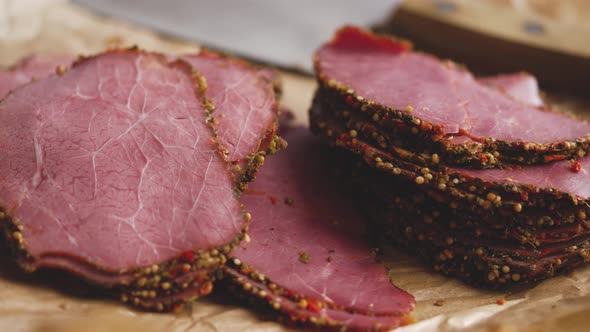 Delicious Peppered Roast Beef Pastrami Slices on Paper with Grains of ...