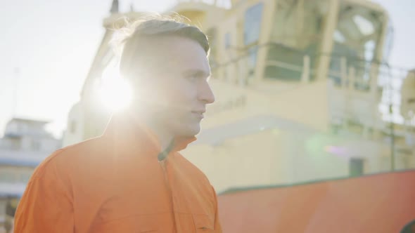 Harbor Master in Orange Uniform Standing in Front of a Large Ship in ...