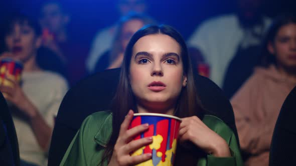 Shocked Woman Jumping at Scary Moment in Cinema. Scared Girl Watching ...