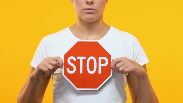 Serious Woman Holding Stop Sign, Stock Footage | VideoHive