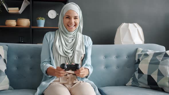 Portrait of Young Hijabi Girl Enjoying Video Game at Home Sitting on ...