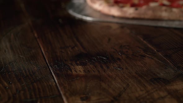 Camera follows a whole pizza with pepperoni being served. Slow Motion ...