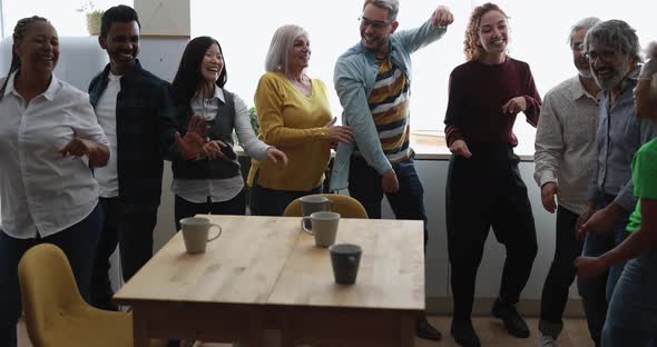 Multiracial happy friends having fun dancing at home kitchen - Multi ...