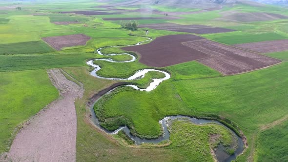 Meander Stream Between The Fields in Wide Valley, Stock Footage | VideoHive
