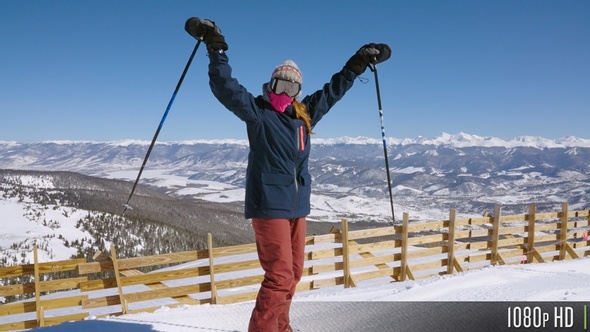 Happy Skier Cheering in Success at the top of a Ski Resort Mountain ...