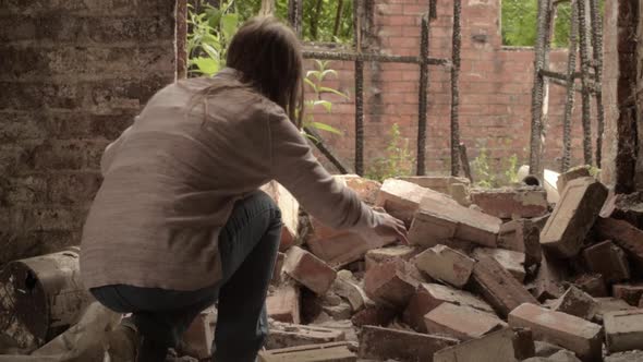 Woman moving rubble and debris after disaster, Stock Footage | VideoHive