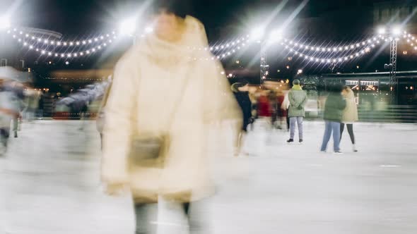Ice Rink with Garland Decoration and People Skating Around, Stock Footage