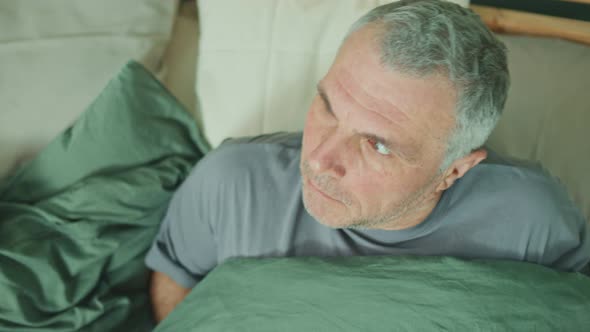 An Alarmed Man Suddenly Wakes Up In Bed Feeling Panic and Anxiety ...