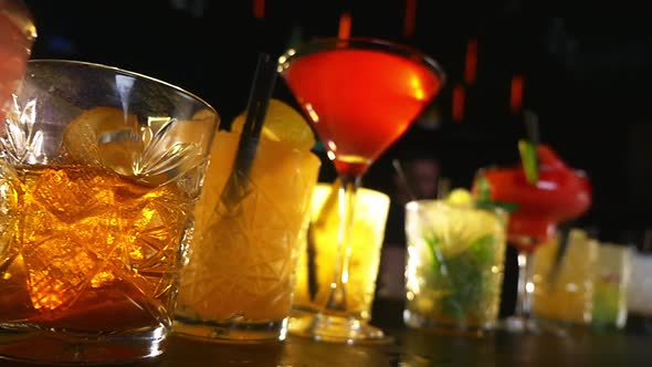 Cocktail Drinks Lined Up on a Bar Table During a Night Party, Stock Footage