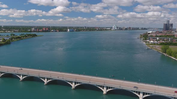 Establishing shot of the Douglas MacArthur Bridge over the Detroit ...