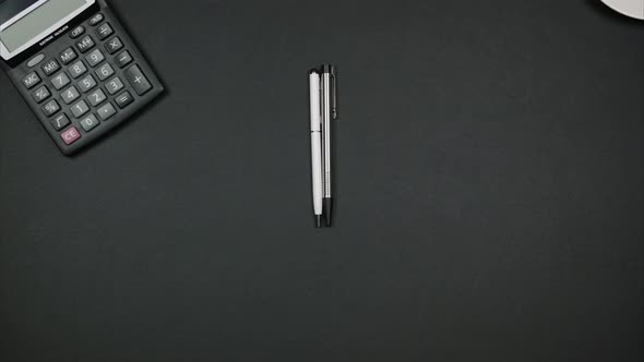 Pens Moving Like Clockwise. Open Notebook on Desktop. Coffee and ...