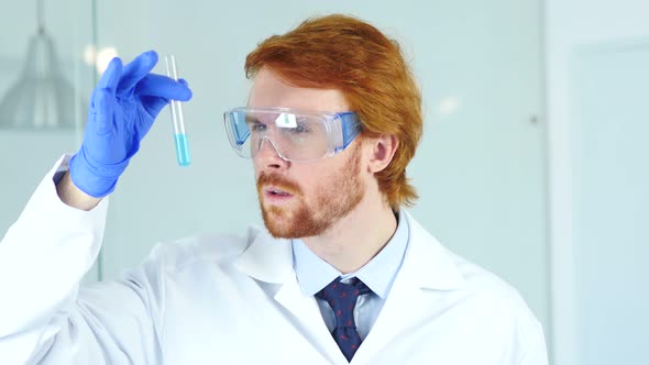 Scientist, Doctor Looking at Blue Solution in Test Tube in Laboratory ...