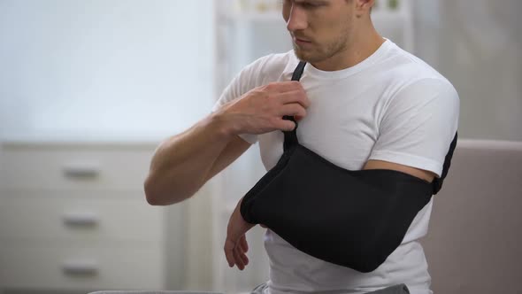 Male Patient Adjusting Arm Sling in Proper Position, Rehabilitation ...
