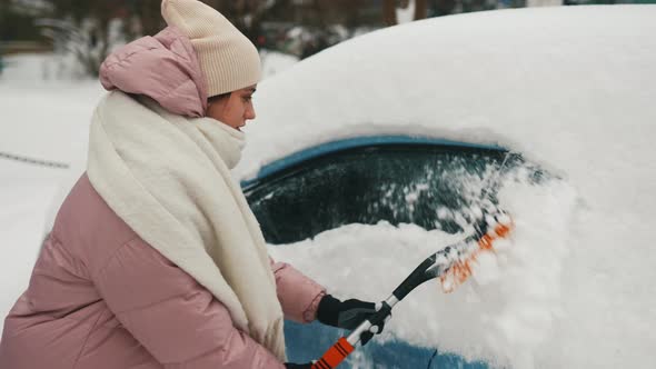 Woman Removing Snow From Car, Stock Footage | VideoHive