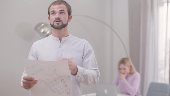Young Confident Caucasian Man Looking Around Room and Taking Notes in ...