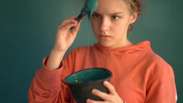 Teenager Watching Paint Fall Off From Paintbrush, Stock Footage | VideoHive