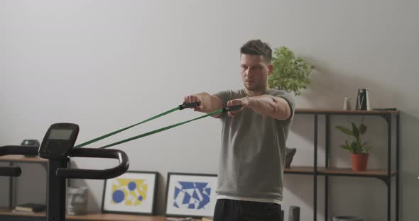 Handsome Man Is Doing Exercises with Sport Rubber Band in Apartment ...