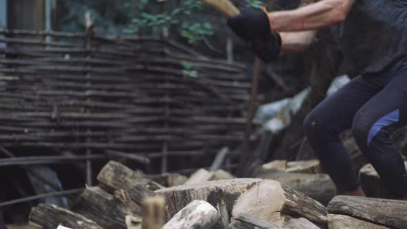 Man Chops Wood Outdoors in Slow Motion. Man's Hands Working with Ax. A ...