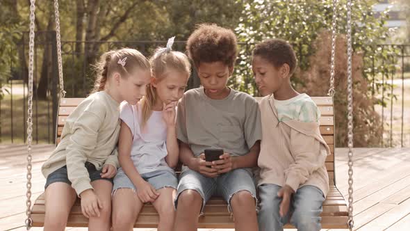 Gen Z Kids with Smartphone at Playground by seventyfourimages | VideoHive